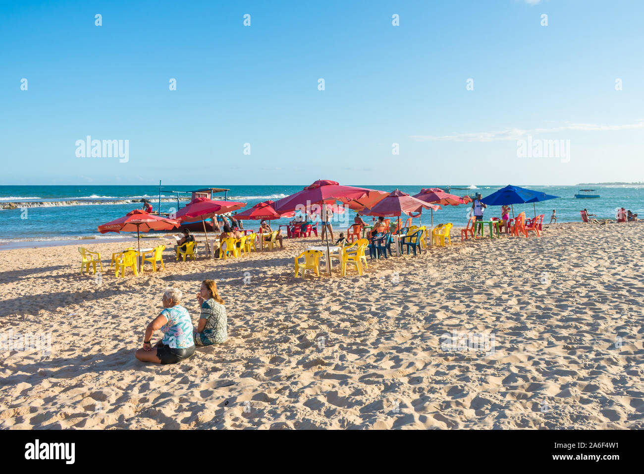 People enjoying the beach in Arembepe, beach village near Salvador ...