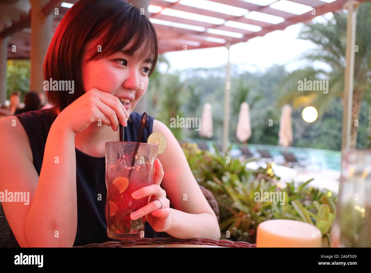 Beautiful young woman drinking a cocktail on holiday in Summer Stock ...