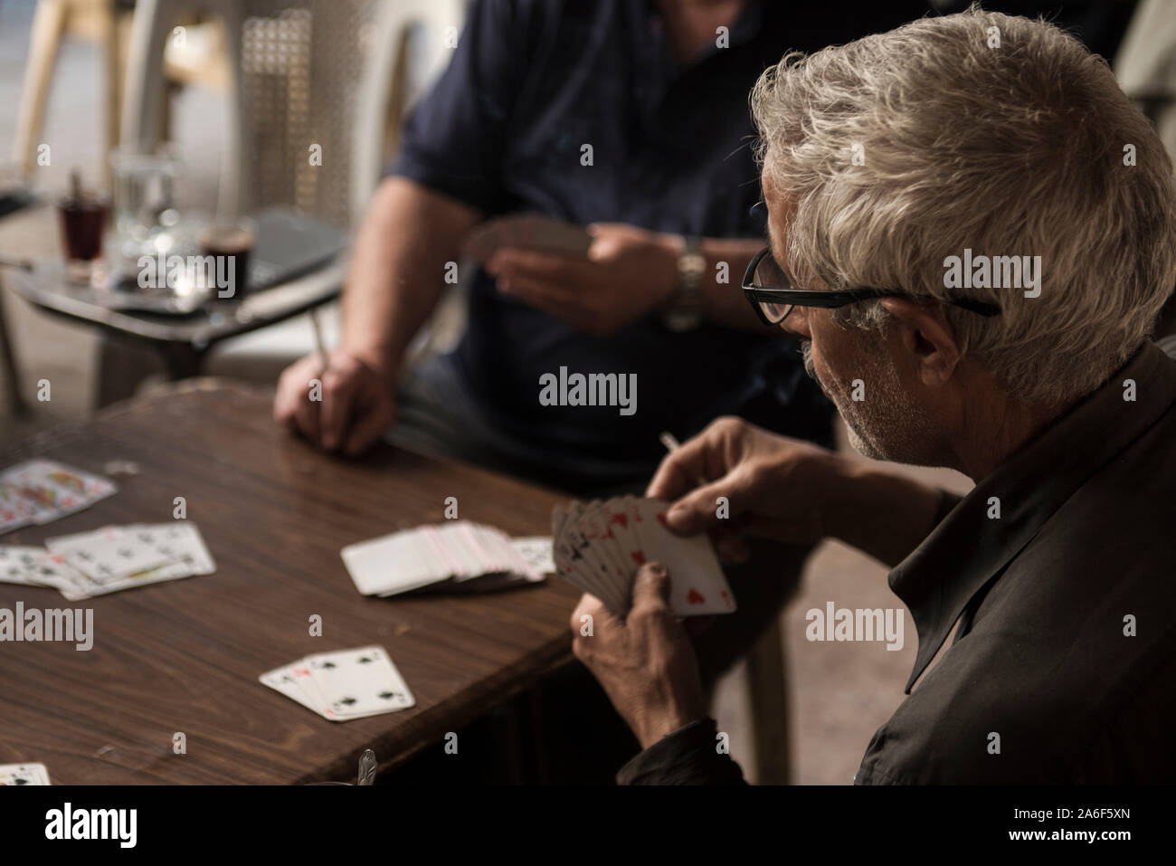 Group of old men playing cards hi-res stock photography and images - Alamy