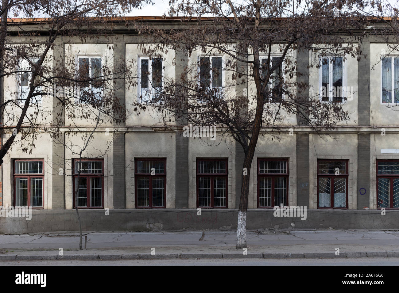 Early spring in the city. There is an old grey house located in Columna ...