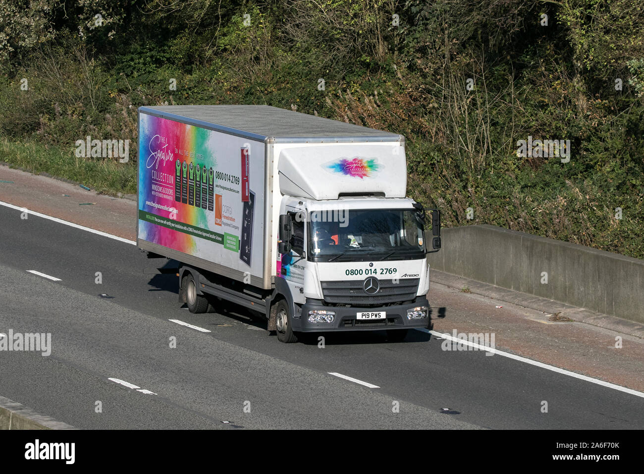 A Mercedes Atego rigid body commercial lorry semi truck traveling on ...