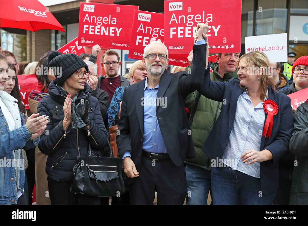 Angela Feeney holds Labour leader Jeremy Corbyn's hand up as he speaks ...