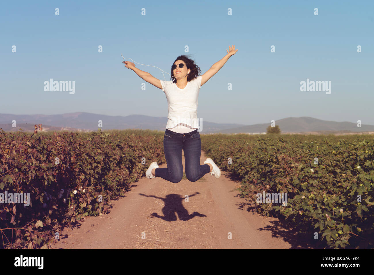 Happy young woman jump in the air in nature Stock Photo - Alamy