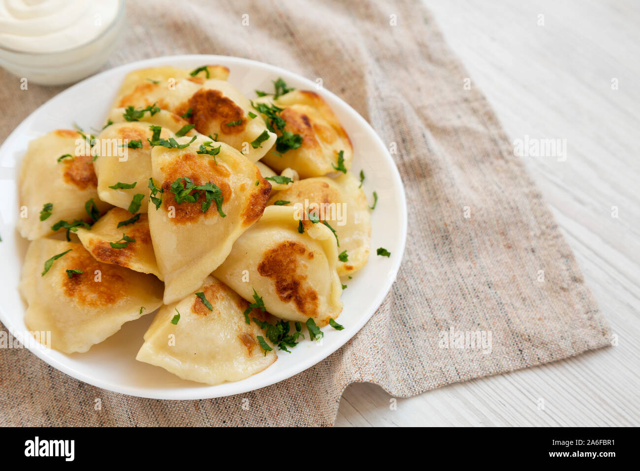 Homemade traditional polish fried potato pierogies on a white plate ...
