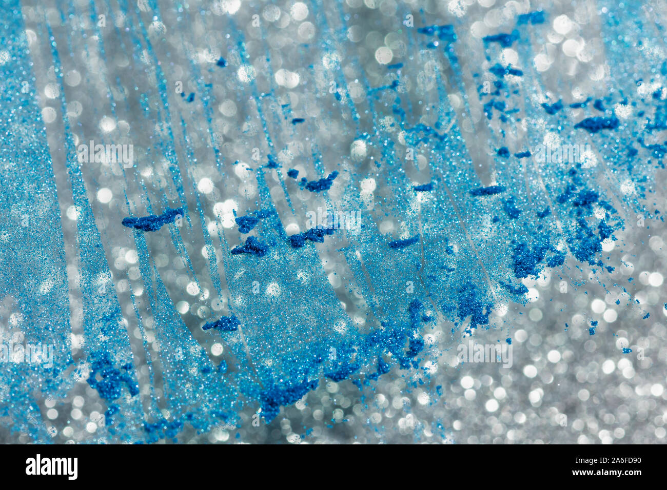 abstract background with silver defocused glitter effect and blue ...
