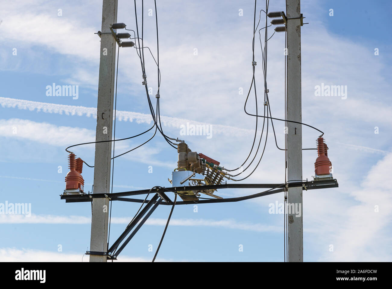 Electrical high voltage fuses on the grey concrete pillars with red ...