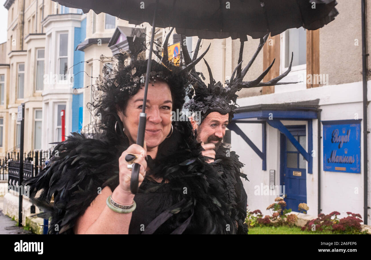 Couple in traditional Goth costumes walking in rain, Whitby Goth ...