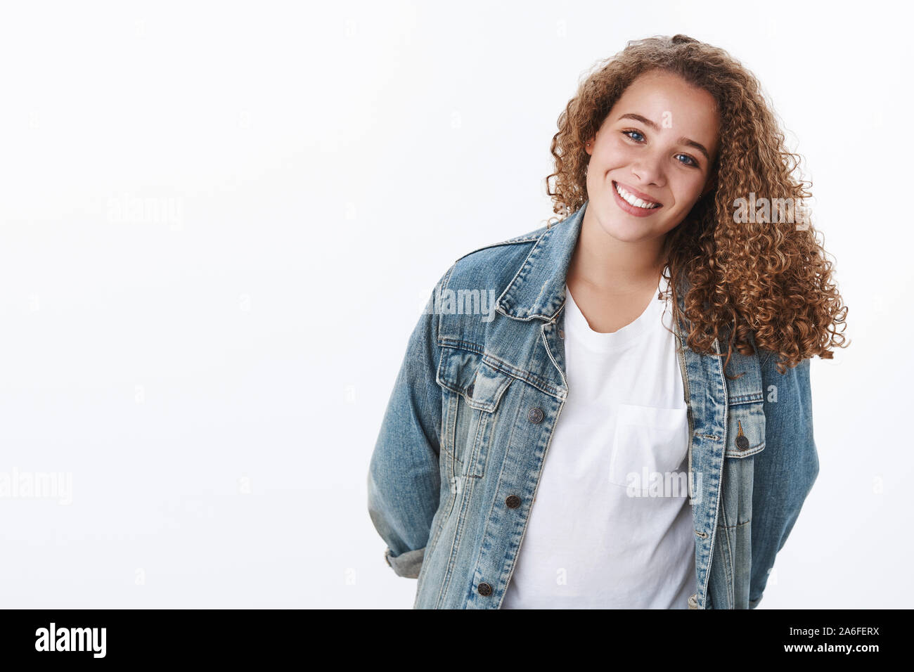 Charismatic cute happy modest chubby young curly-haired girl hold hands ...