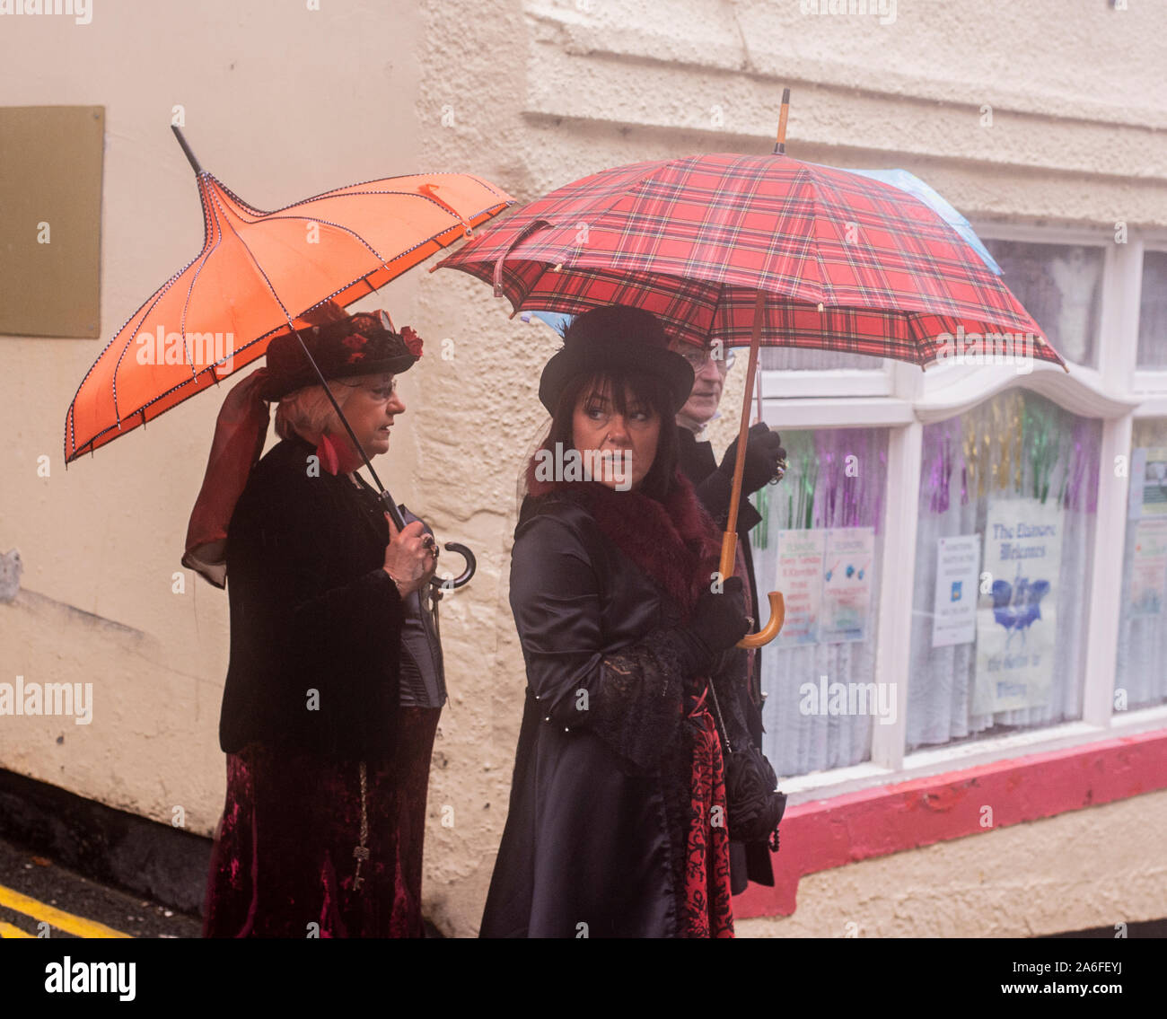 Two ladies in traditional Goth costumes walking in rain, Whitby Goth ...