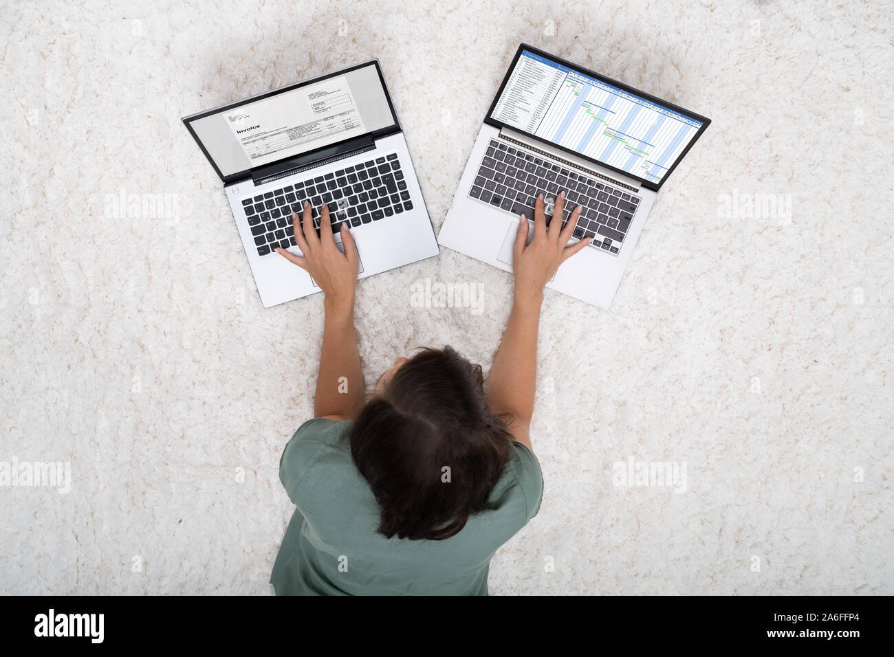 Woman Working On Two Laptops At The Same Time Stock Photo - Alamy