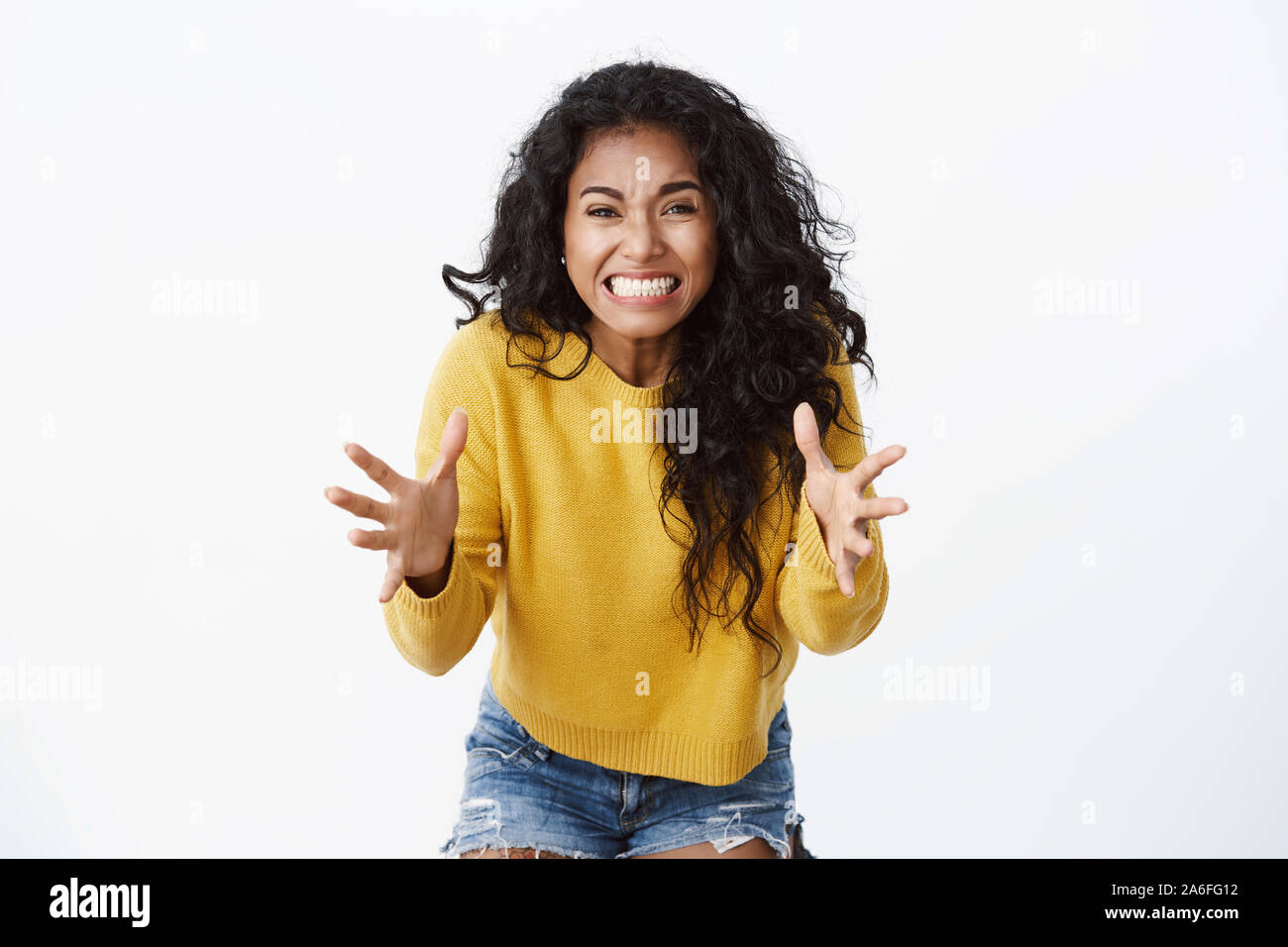 Pretty african american woman watching intense game cringing from ...