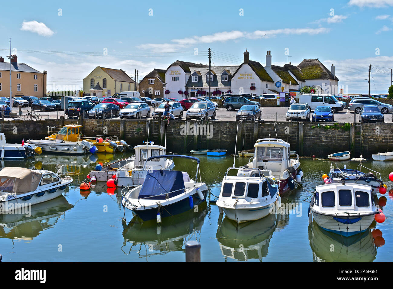 A view across the pretty harbour at West Bay. Fishing & pleasure boats ...