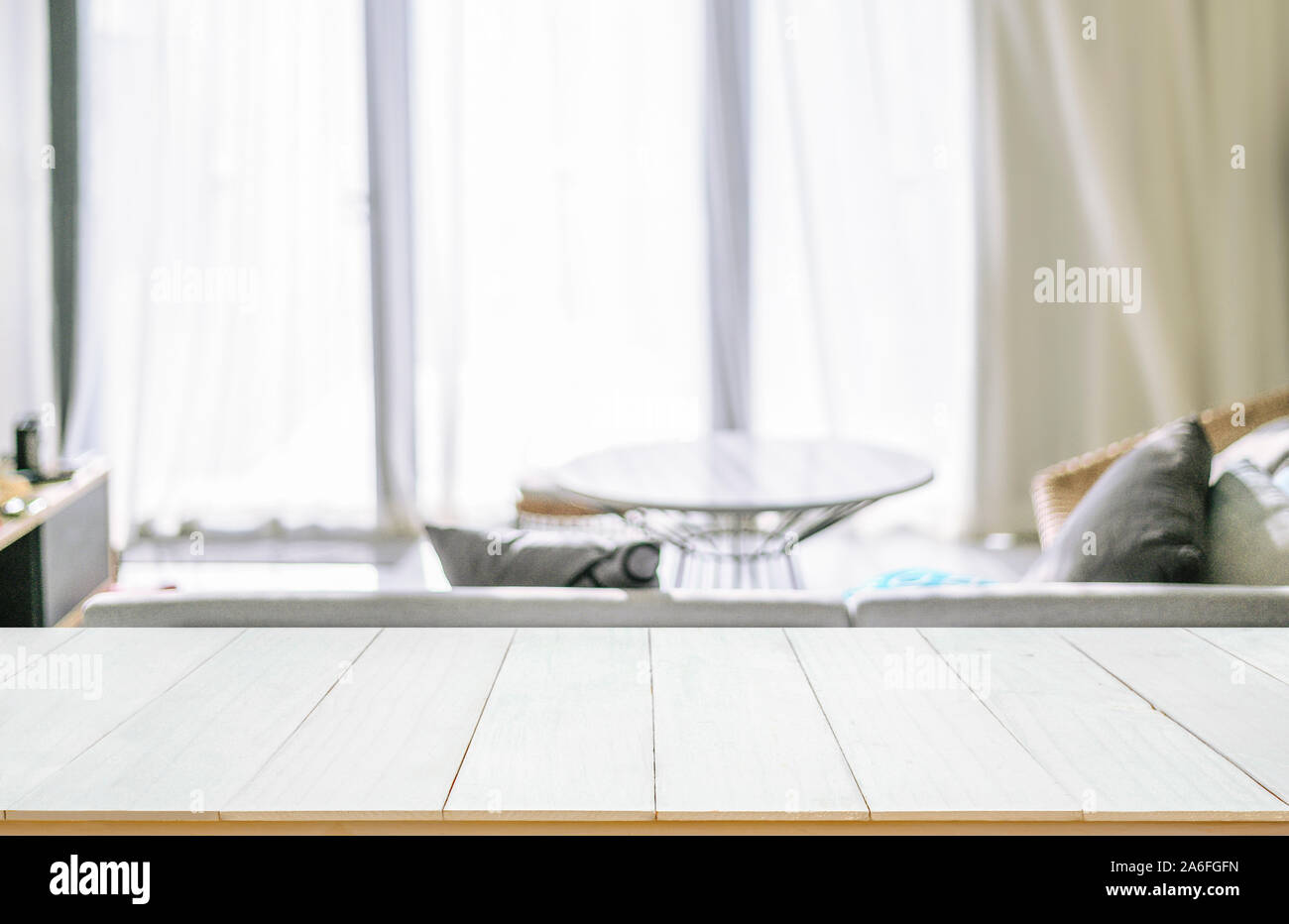wooden table top with blur of modern living room interior Stock Photo ...