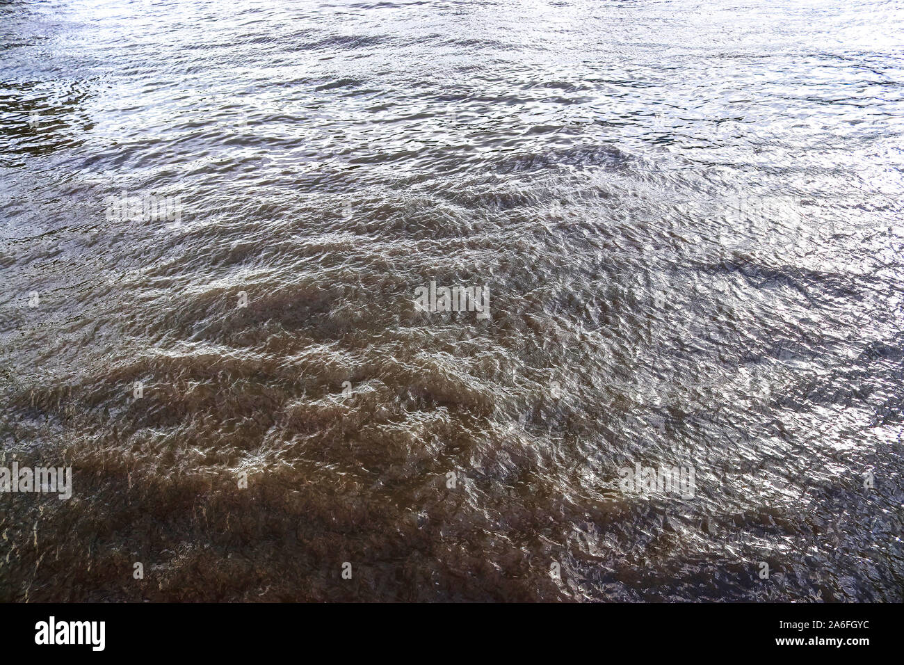 Detailed close up view on reflective water surface with waves and ...