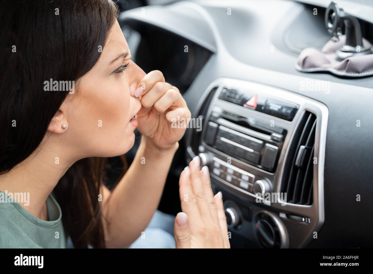 Woman Covering Her Nose From Bad Smell Inside The Car Stock Photo - Alamy