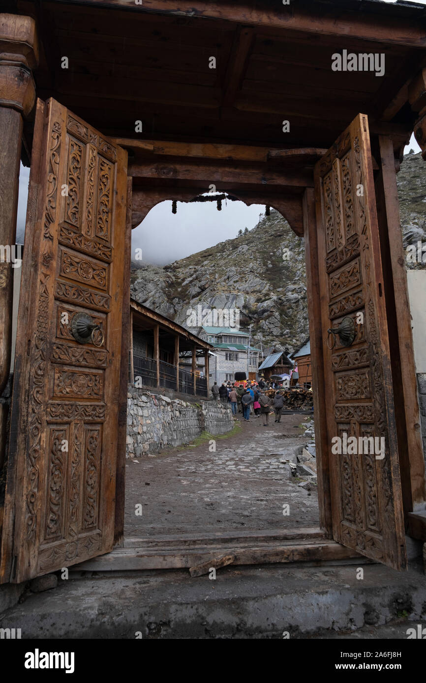 The richly carved back entrance door of the Mathi temple. Chitkul ...
