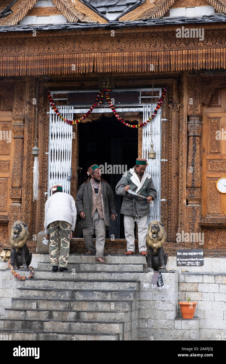 The priest of Mathi temple attaching a piece of cloth to bell at the ...