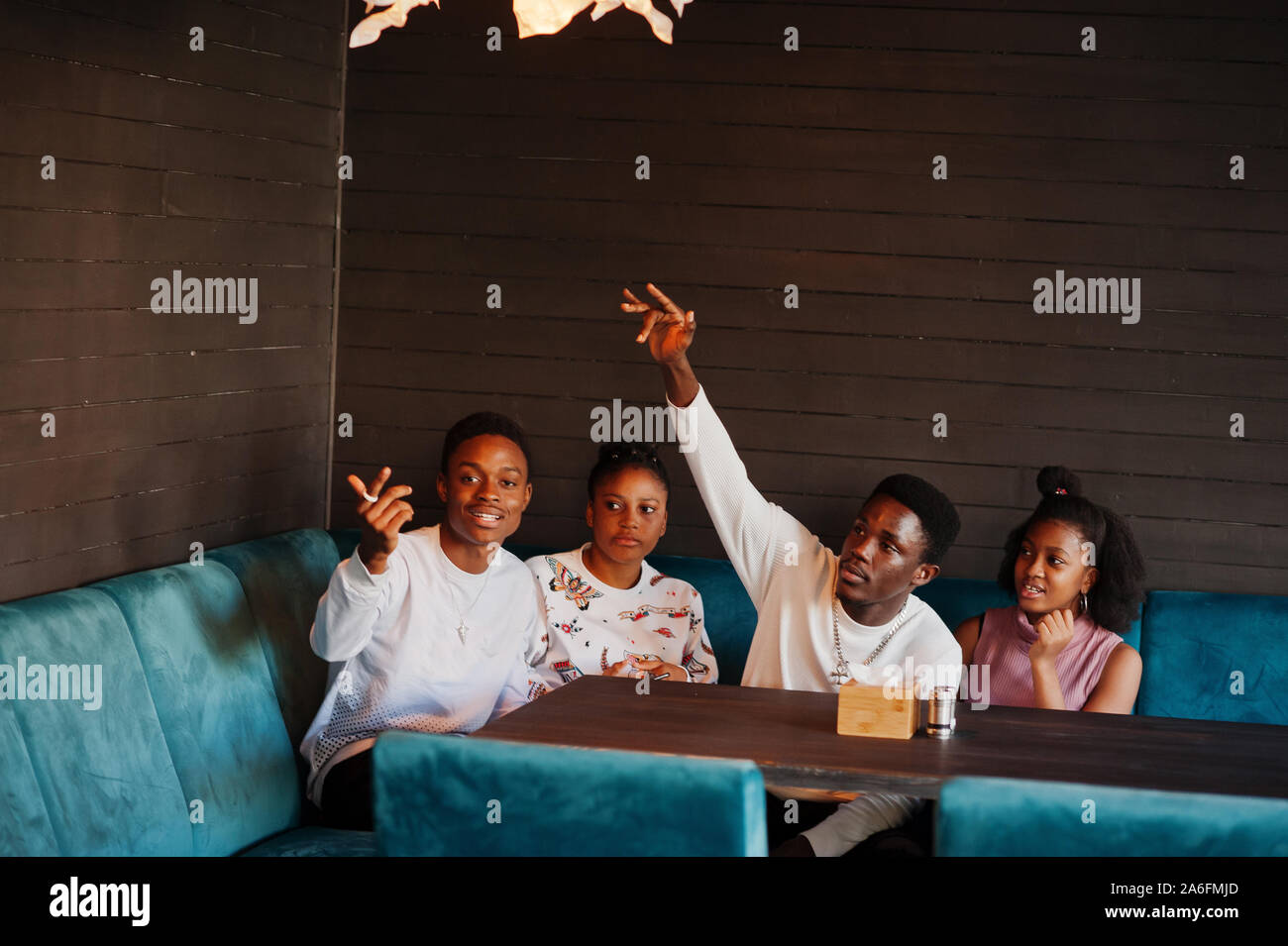 Happy african friends sitting and chatting in cafe. Group of black ...
