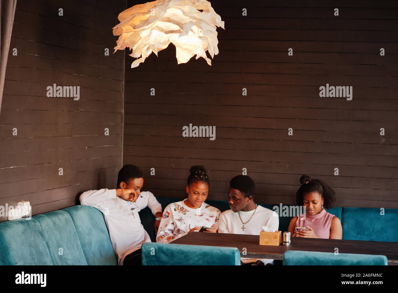 Happy african friends sitting and chatting in cafe. Group of black ...