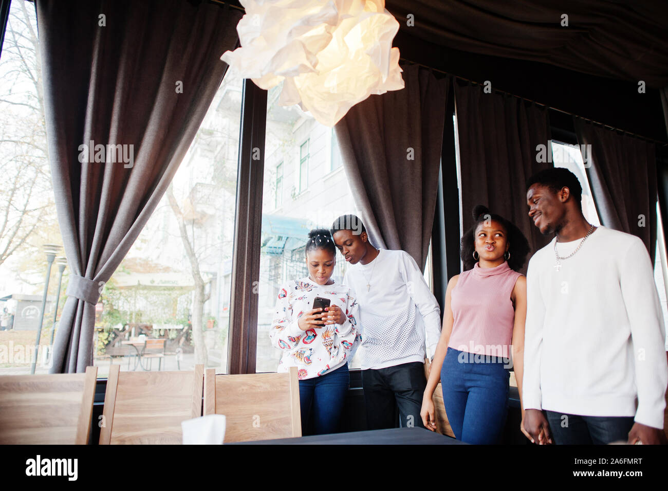 Happy african friends chatting in cafe. Group of black peoples meeting ...