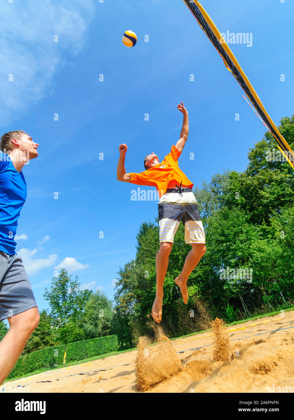 Intensive game on beachvolleyball court, fighting spirit to save the ...