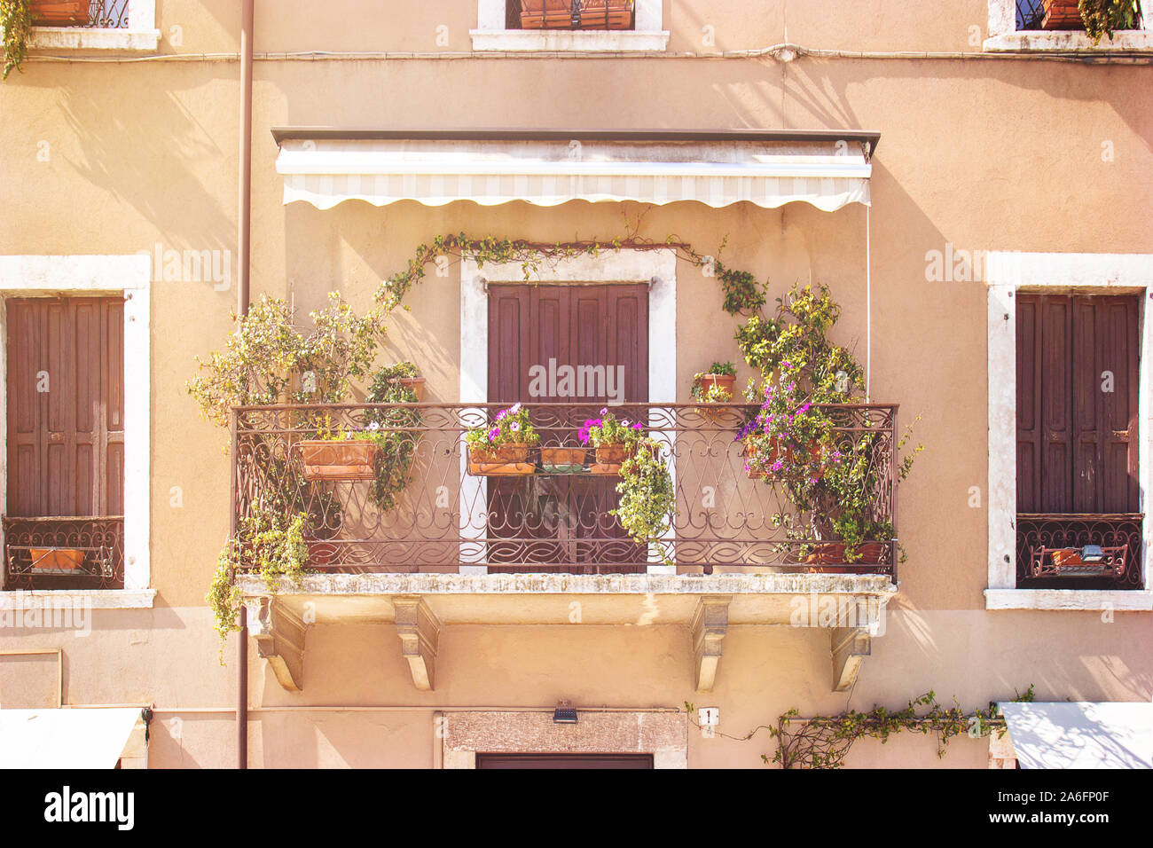 Mediterranean balcony with flowers. Building exterior in a italian ...