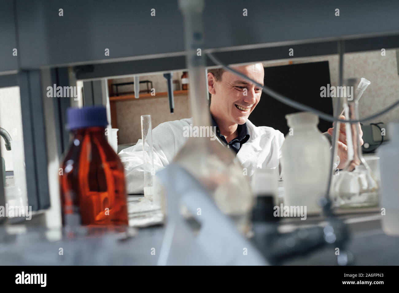 young scientist conducts chemical experiments with liquids in science ...
