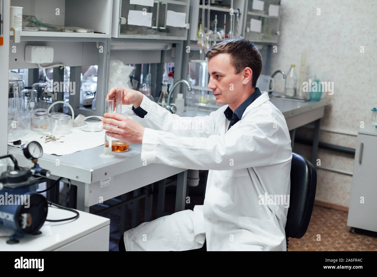 scientist conducts chemical experiments with liquids in a scientific ...