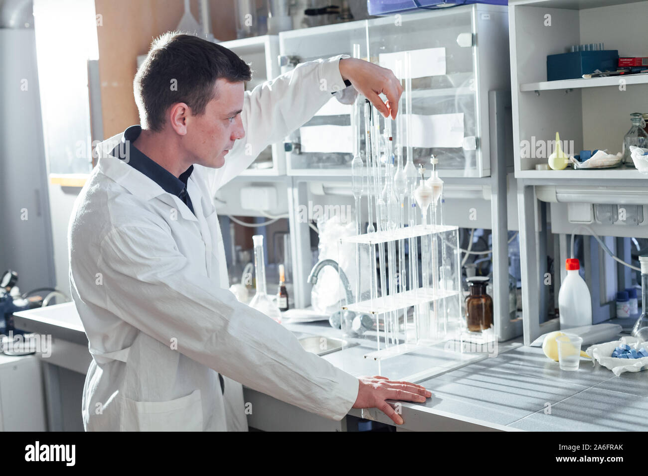 scientist conducts chemical experiments with liquids in a scientific ...
