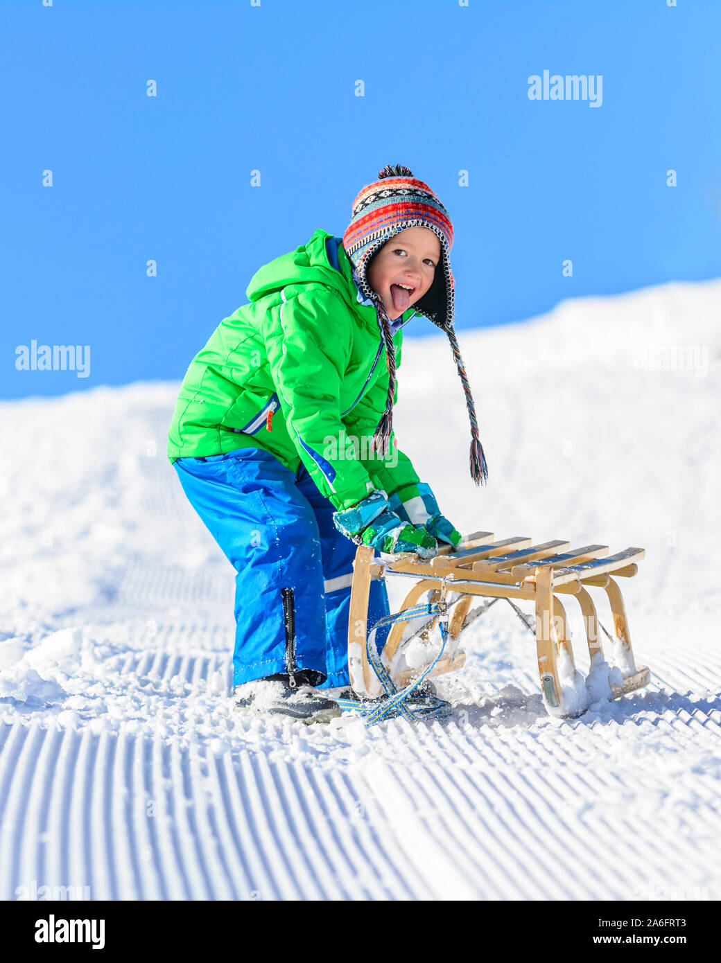 Funny afternoon in wintertime on sleigh slope Stock Photo - Alamy