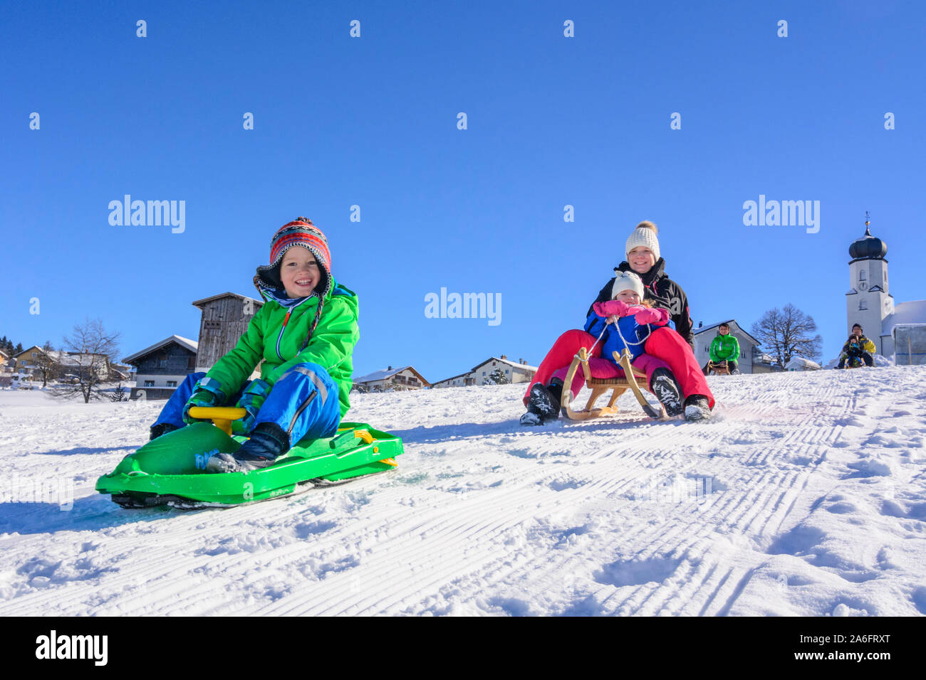 Funny afternoon in wintertime on sleigh slope Stock Photo - Alamy