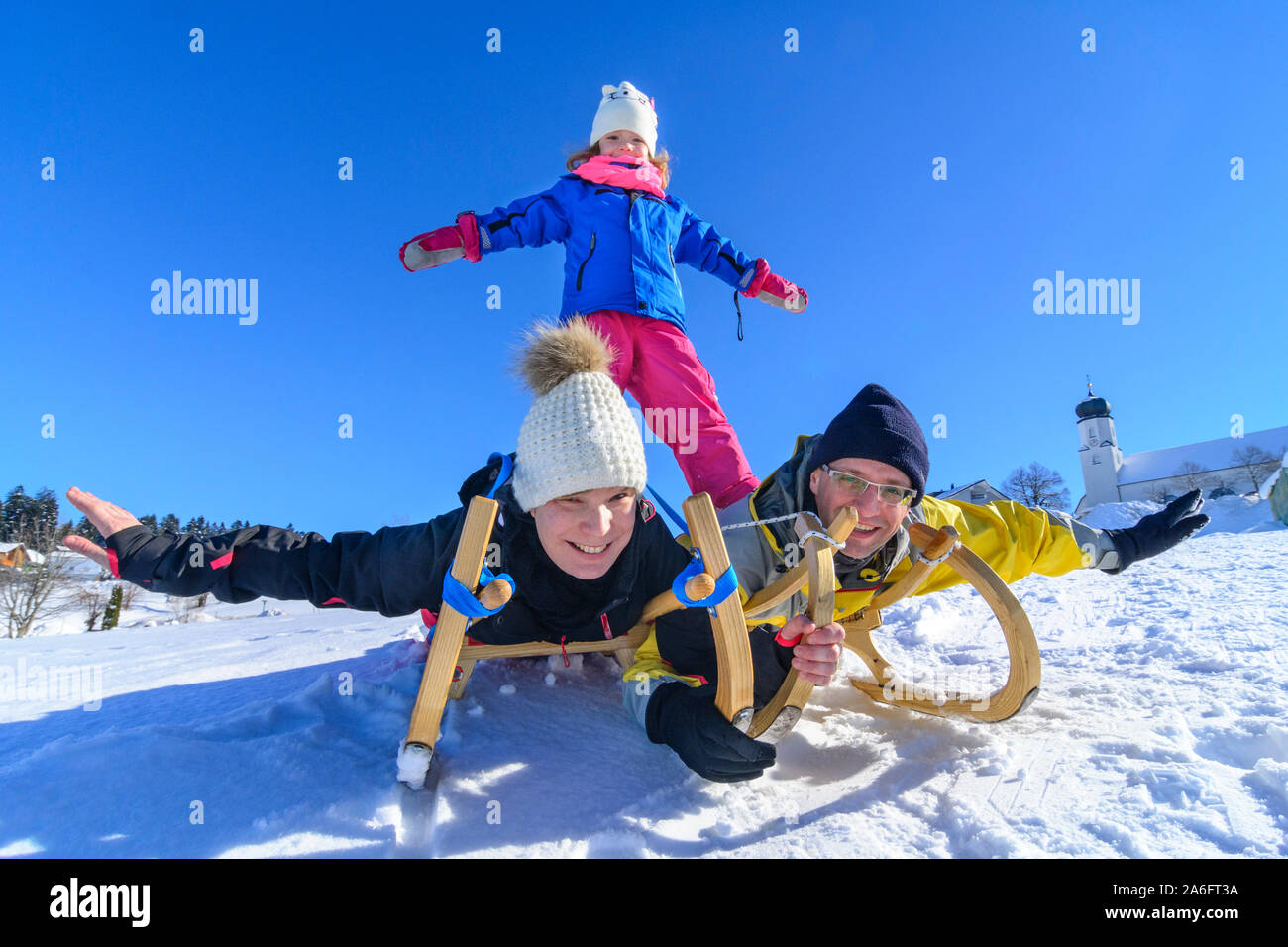 Funny afternoon in wintertime on sleigh slope Stock Photo - Alamy