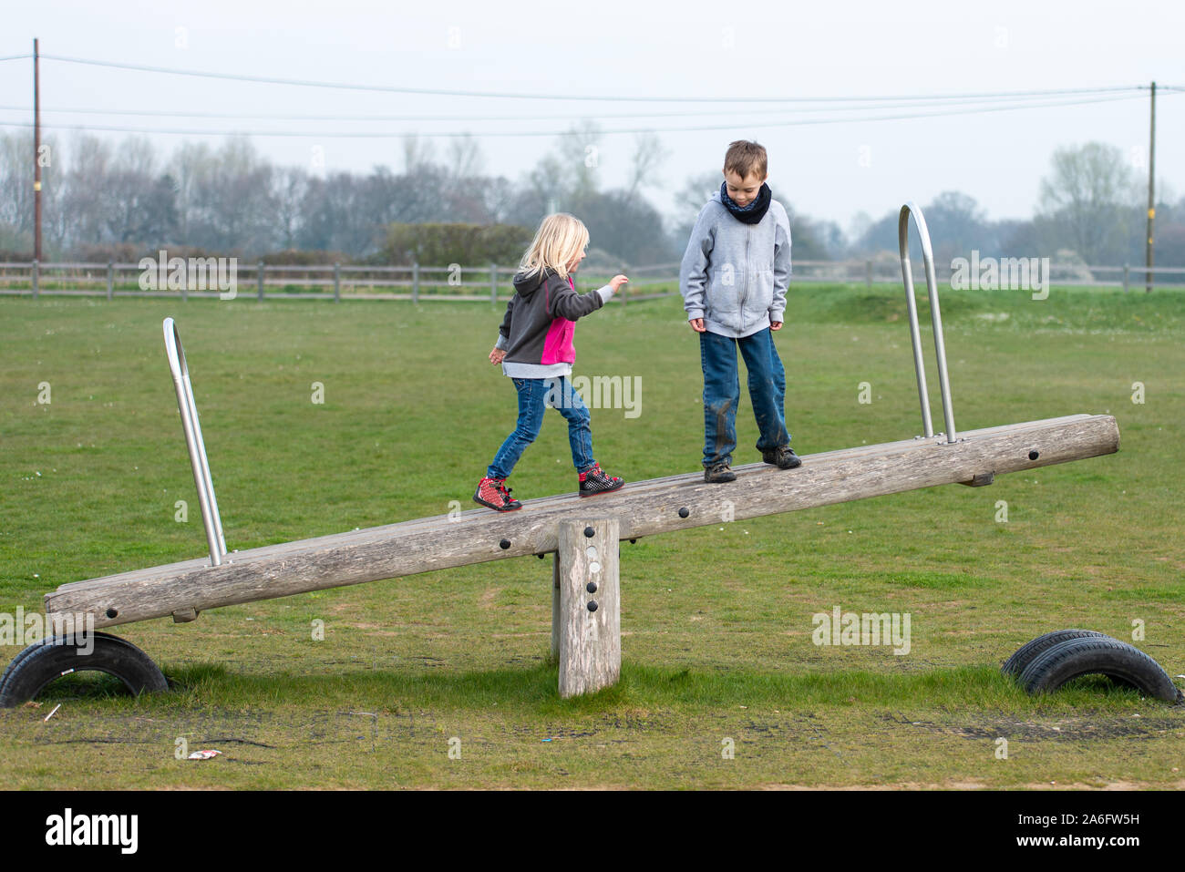 A Handsome Boy With ADHD Autism Asperger Syndrome Plays With His Sister At The Park On The a-handsome-boy-with-adhd-autism-asperger-syndrome-plays-with-his-sister-at-the-park-on-the
