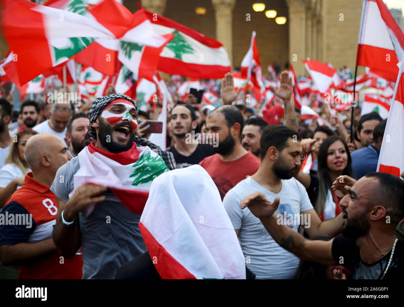 Beirut, Lebanon. 26th Oct, 2019. Lebanese demonstrators wave national ...