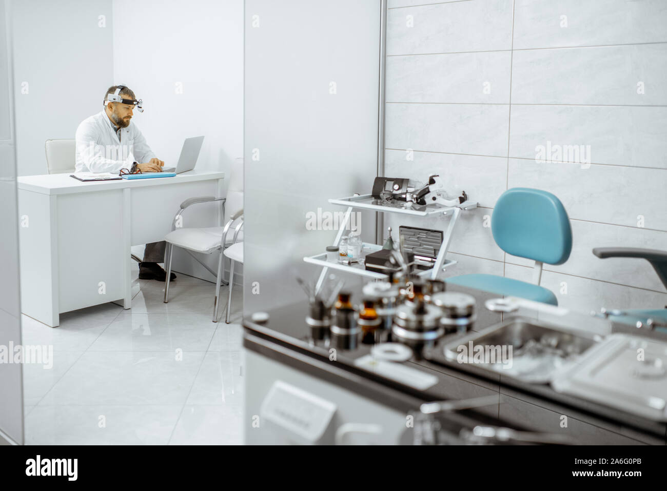 Otolaryngology office with ENT workstation and senior doctor working ...