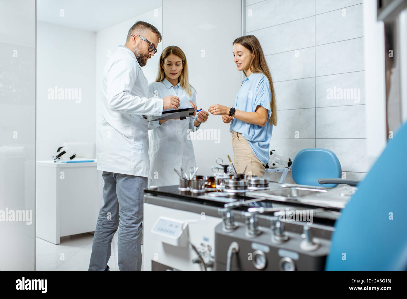 Young patient with two doctors during a medical consultation standing ...