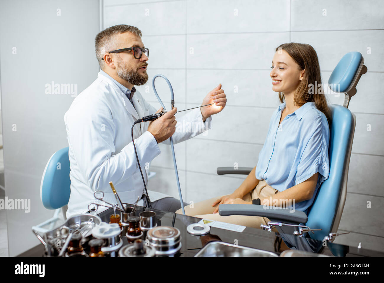 Senior otolaryngologist preparing for the endoscopic examination of ENT ...