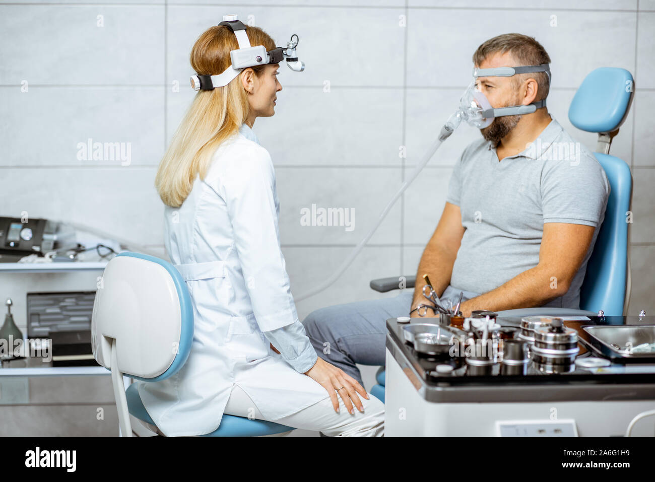 Adult man during a medical breathing treatment with respiratory mask ...