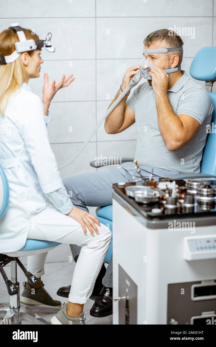 Adult man during a medical breathing treatment with respiratory mask ...