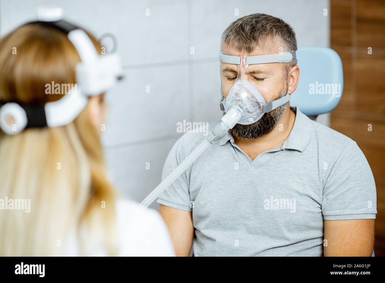 Adult man during a medical breathing treatment with respiratory mask ...