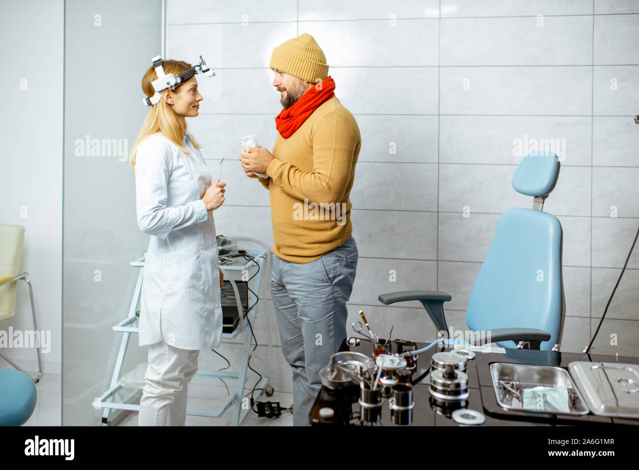 Sick patient in warm clothes with runny nose during a medical ...