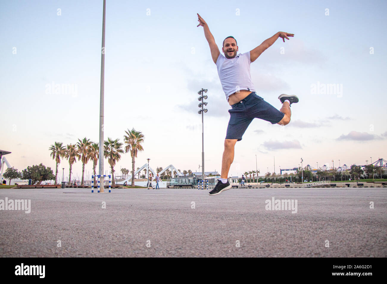A happy man jumping at park in the morning Stock Photo - Alamy