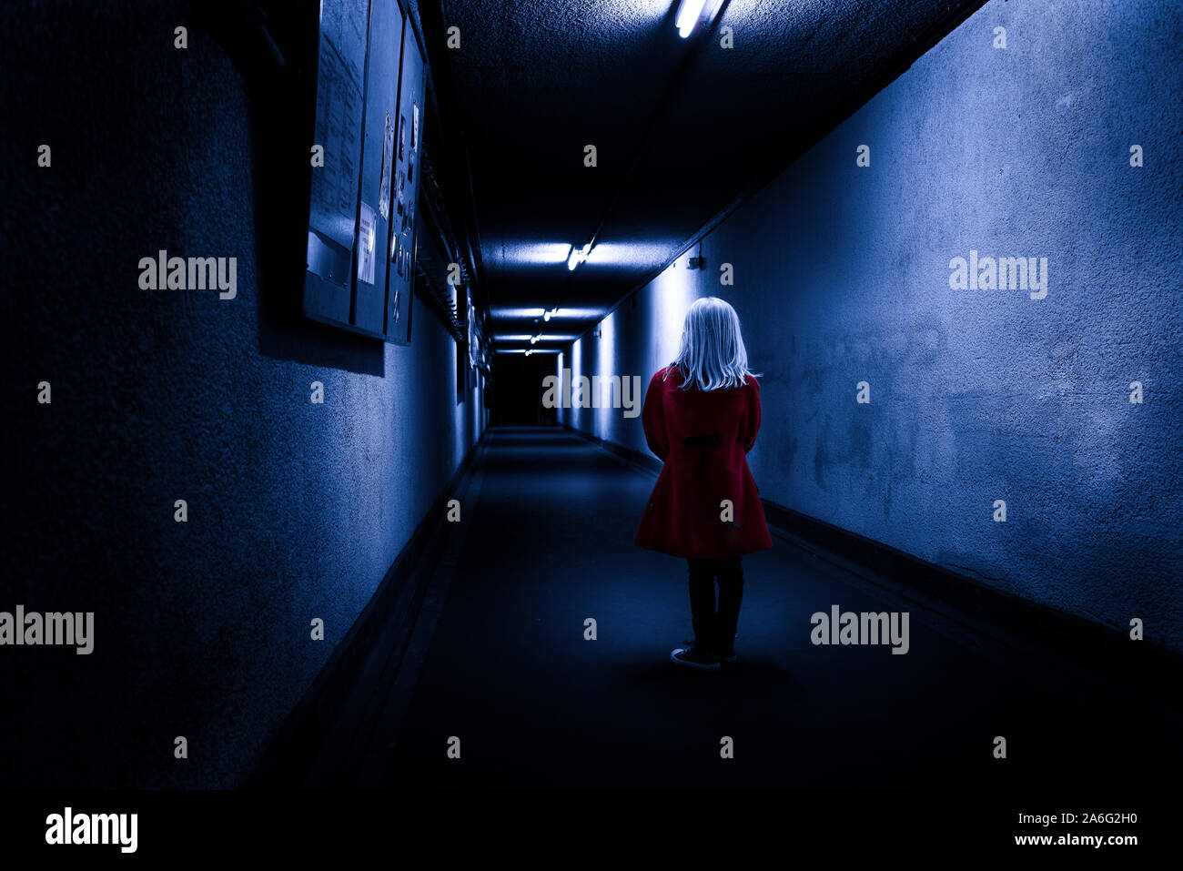 Spooky, image of a little girl wearing a red coat in the corridor to a ...
