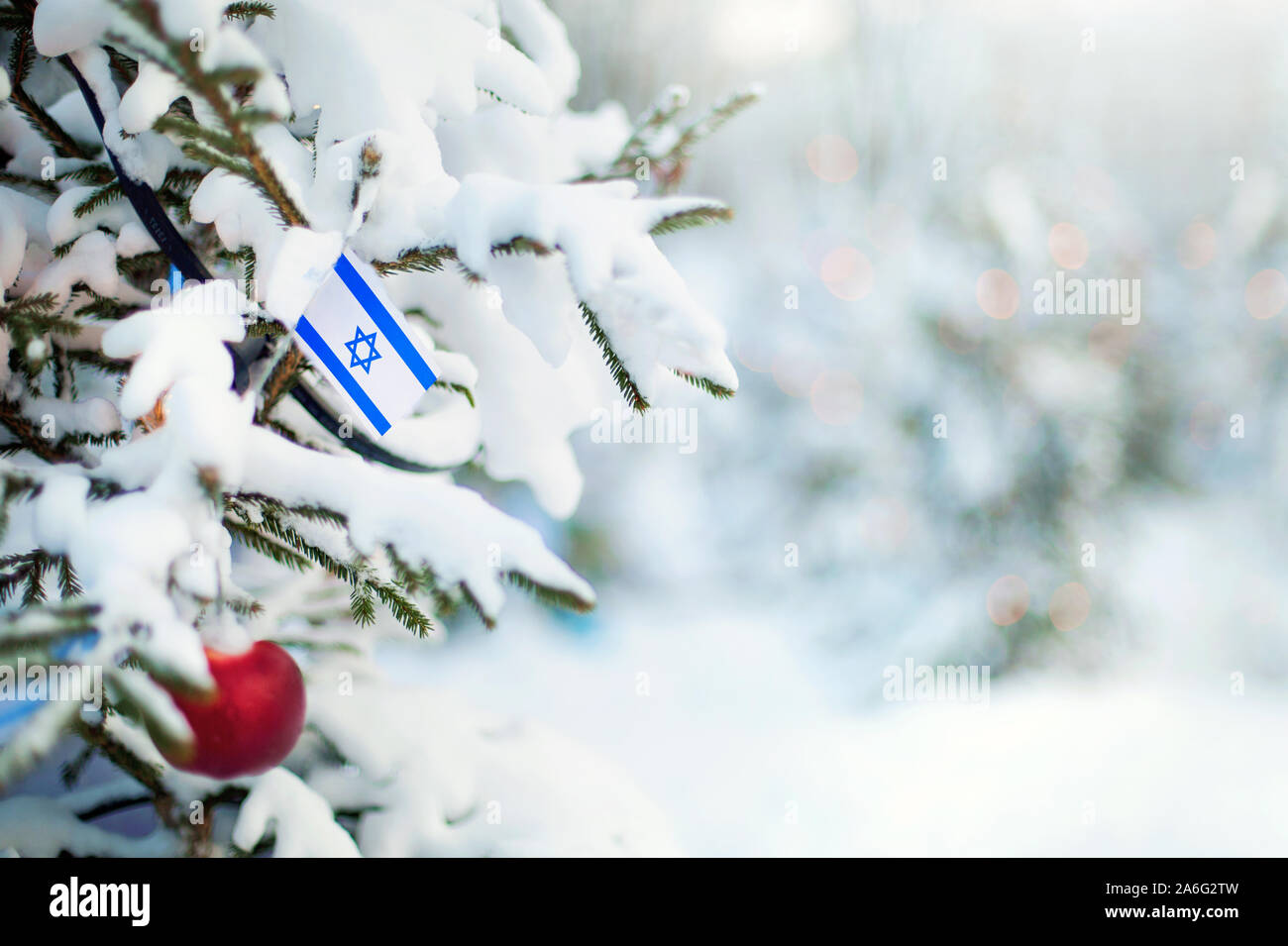 Christmas Israel. Xmas tree covered with snow, decorations and a flag ...