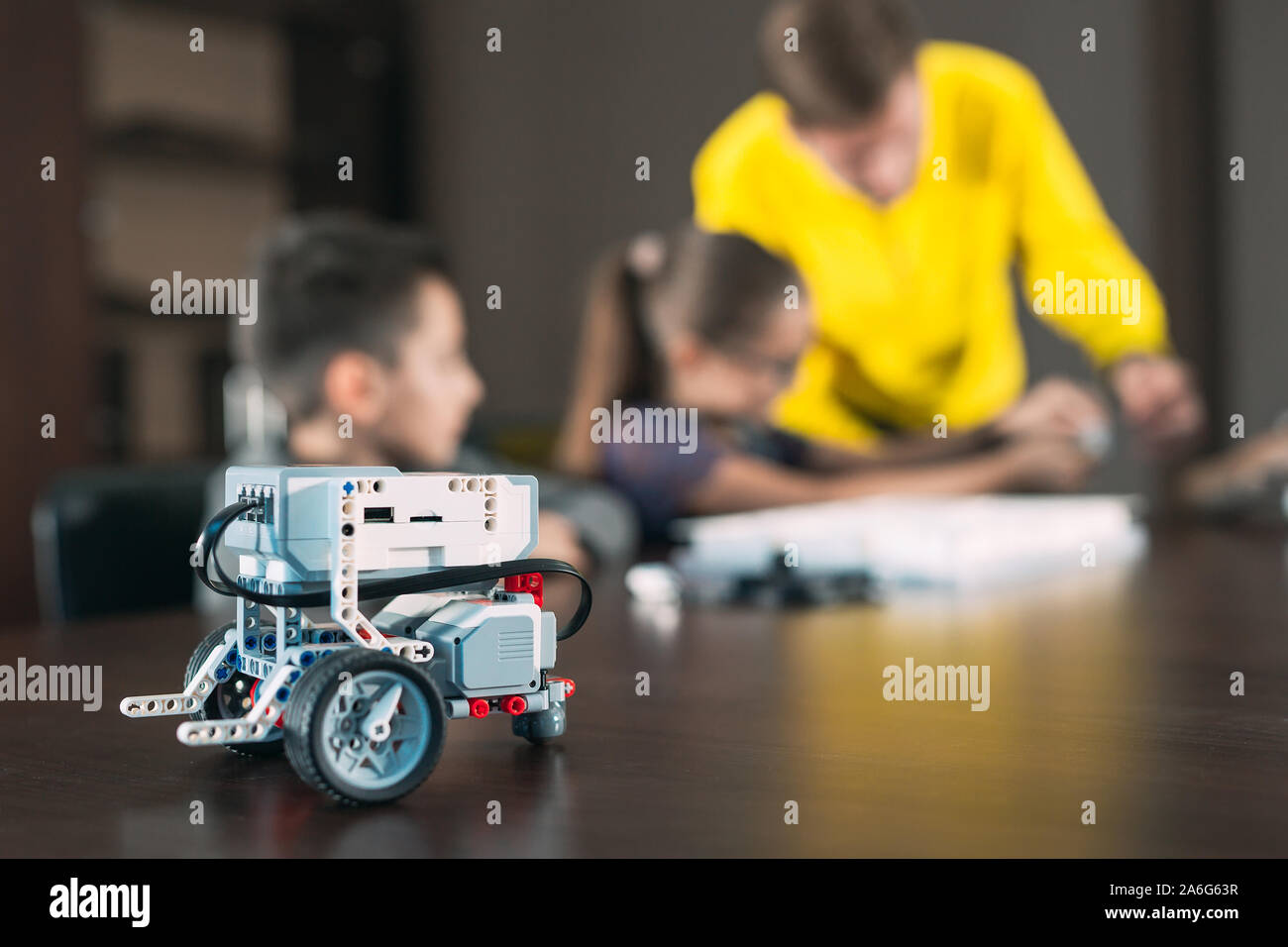Kids creating robots with teacher. Early development, diy, innovation ...