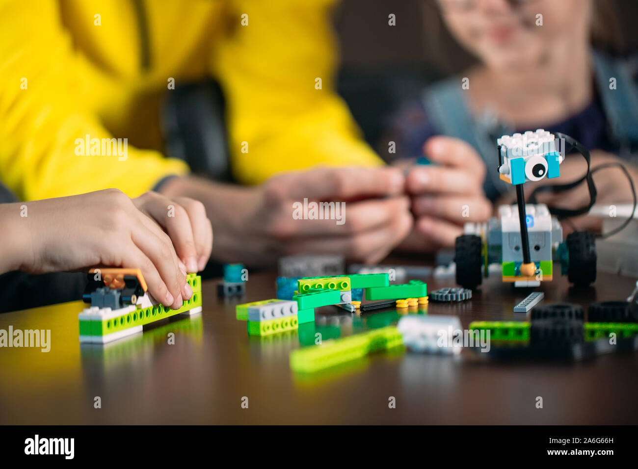 Kids creating robots with teacher. Early development, diy, innovation ...