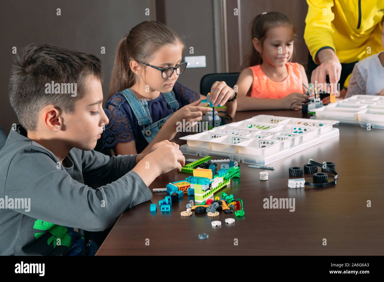 Kids creating robots with teacher. Early development, diy, innovation ...