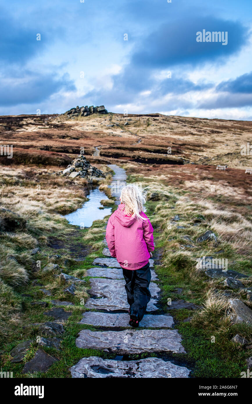 A pretty young girl, walking, hiking and mountain climbing in the ...