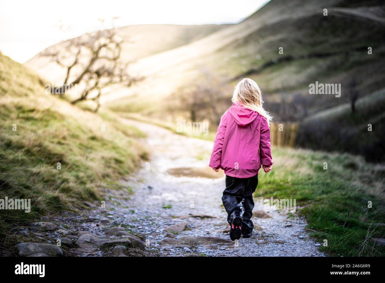 A pretty young girl, walking, hiking and mountain climbing in the ...