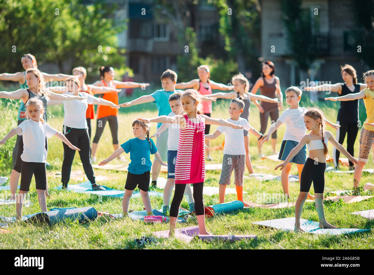 Yoga classes outside on the open air. Kids Yoga Stock Photo - Alamy